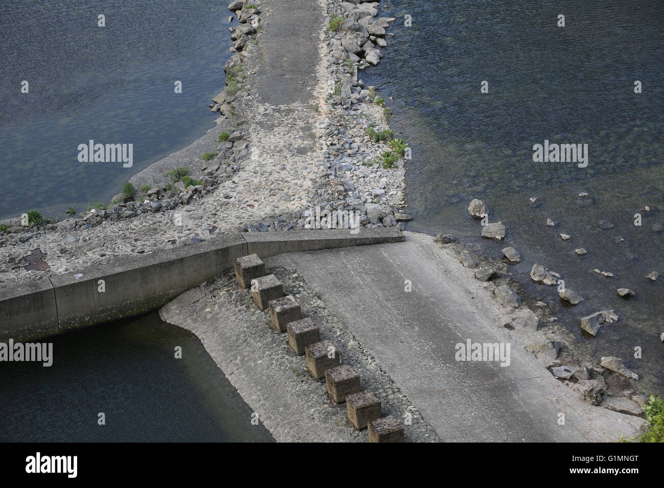 Rock dams with road and water on all sides Stock Photo - Alamy