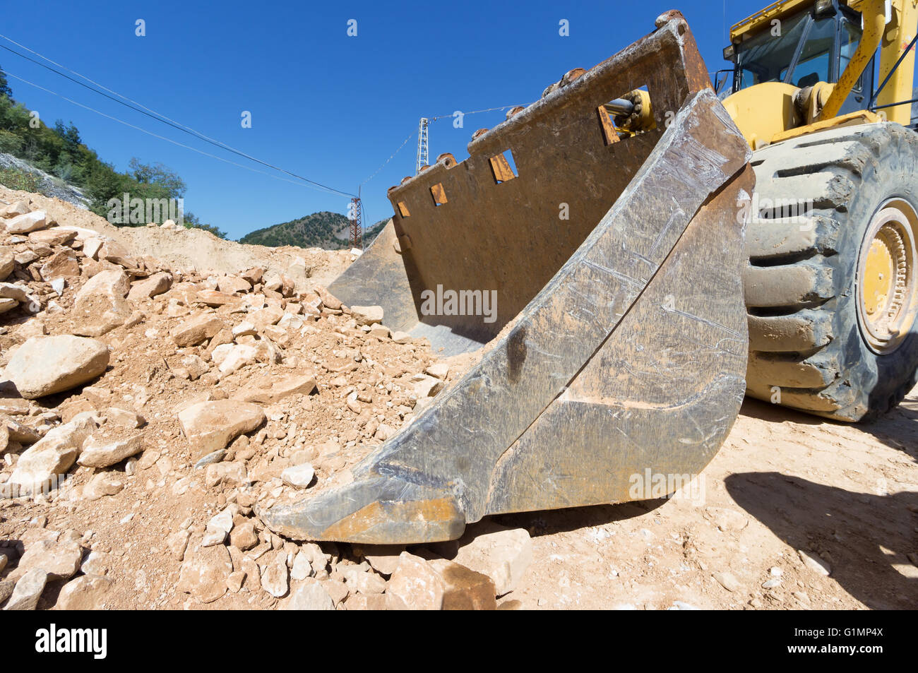 Excavator with backhoe loading soil at eathmoving works in construction ...