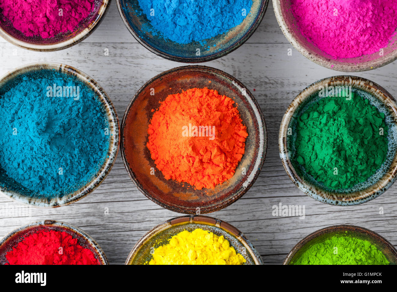 Colorful Holi powder in cups closeup. Top view Stock Photo - Alamy