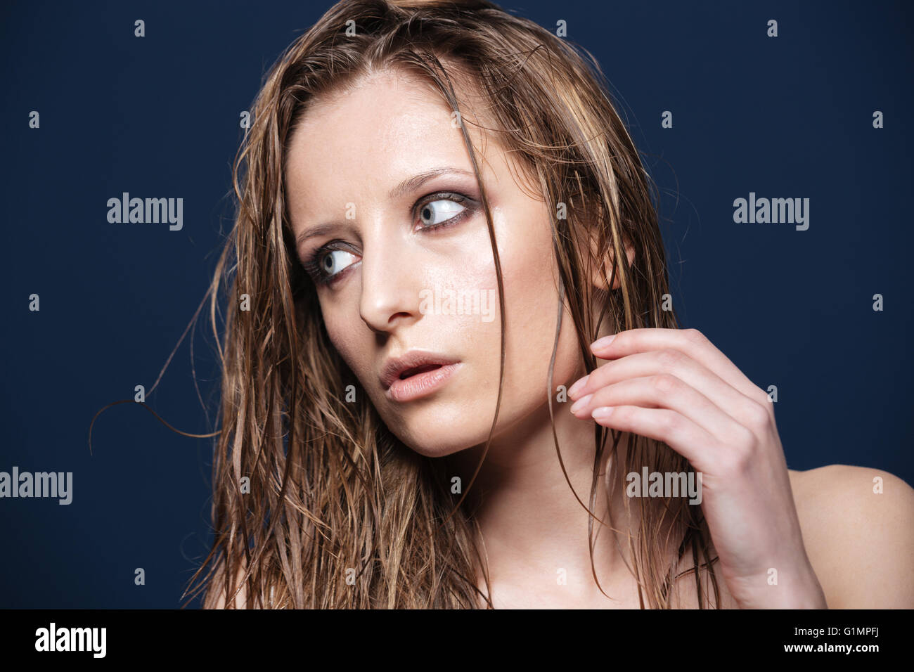 Beauty portrait of a woman with cute face looking away over blue ...