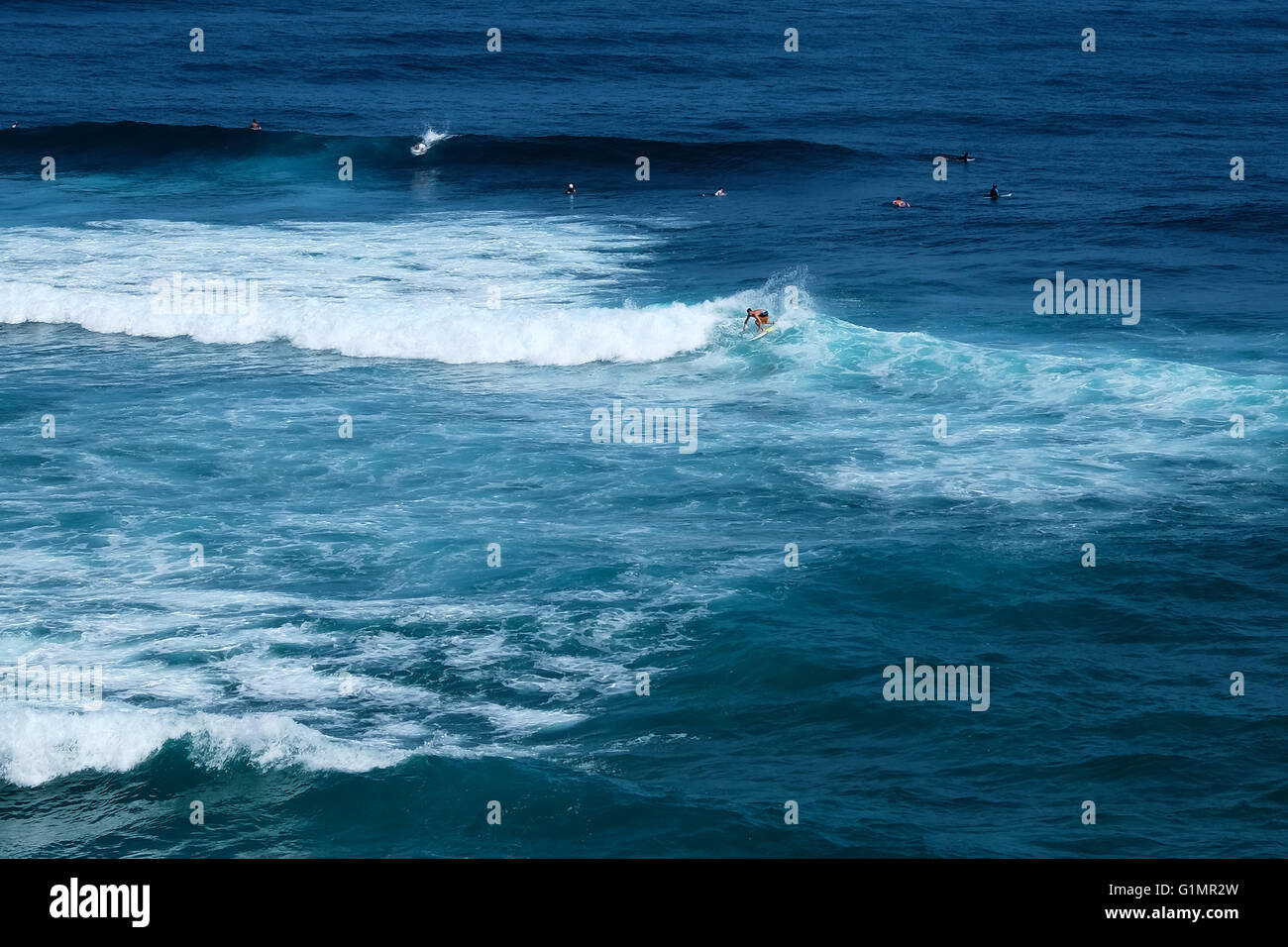 Surfers enjoying the waves in the ocean Stock Photo - Alamy