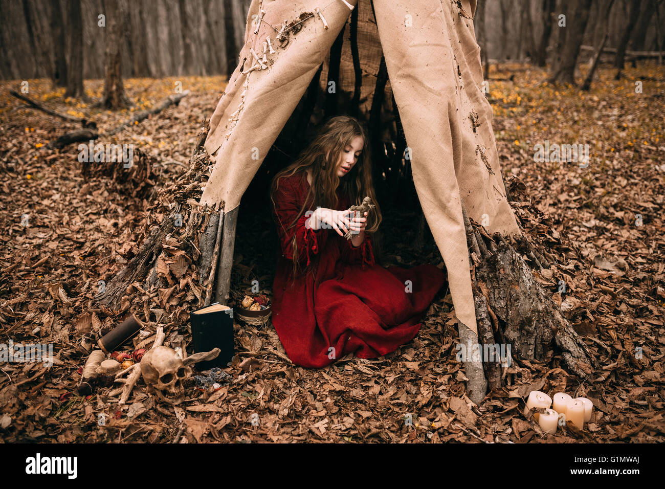 Young witch in autumn forest hi-res stock photography and images - Alamy