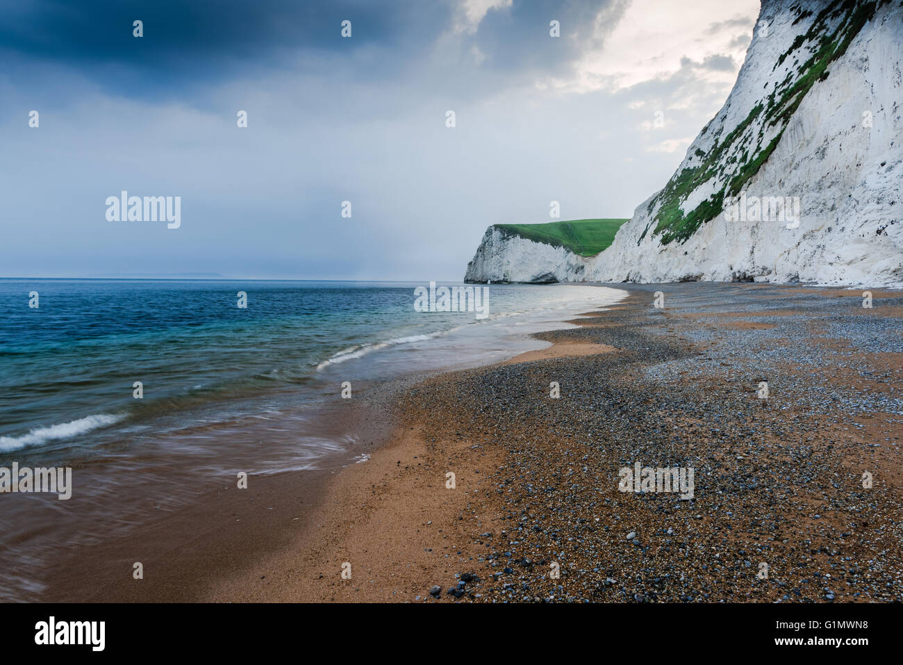 White cliffs at sunset in Dorset with long beach Stock Photo - Alamy