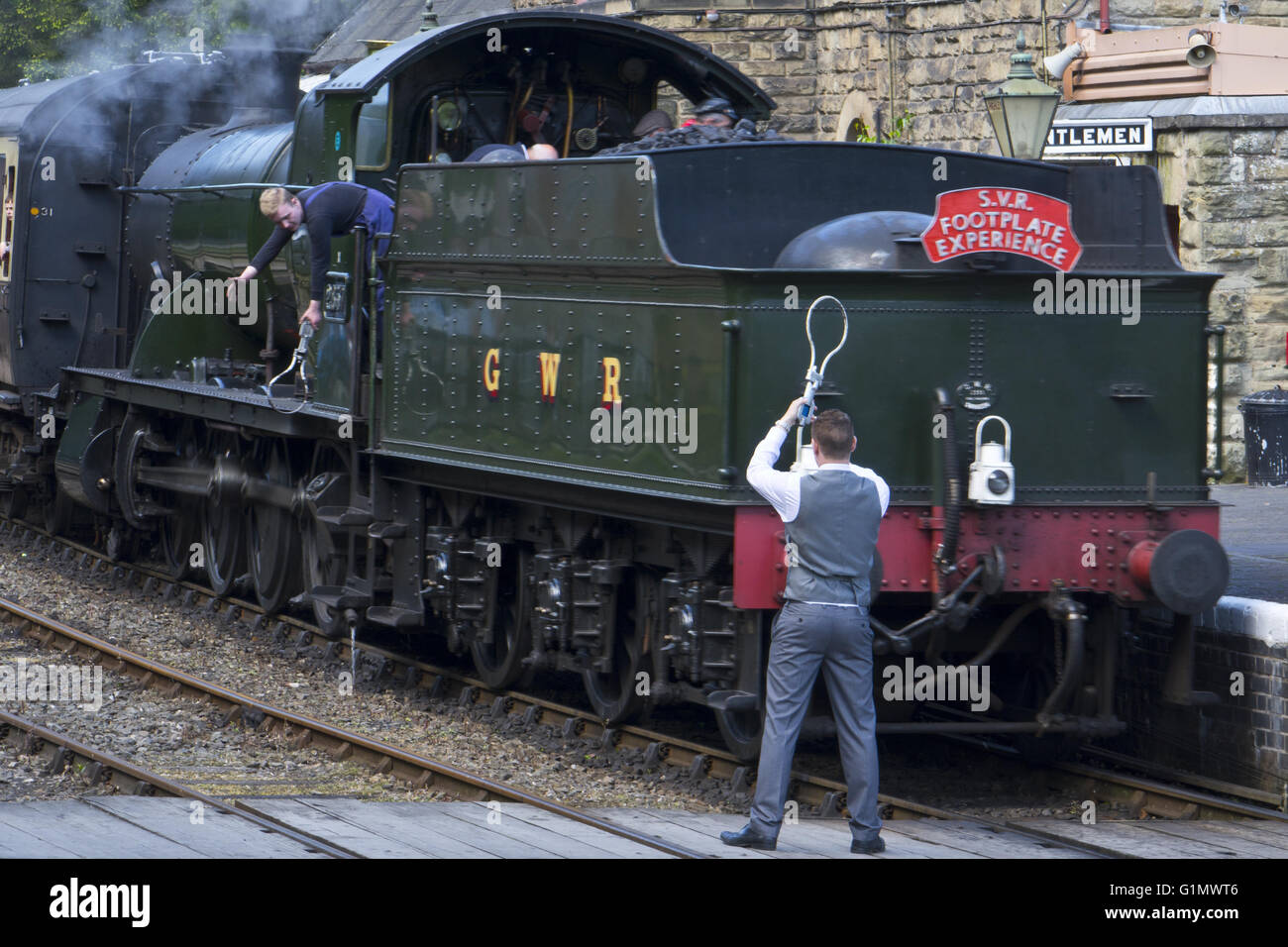 train driver and signalman exchange train token tokens Stock Photo - Alamy