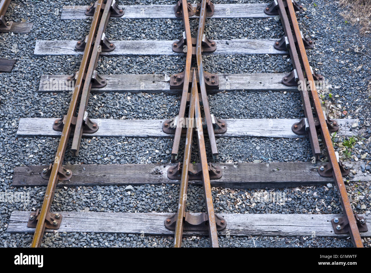Railway lines crossing diamond junction diamond crossed Stock Photo - Alamy