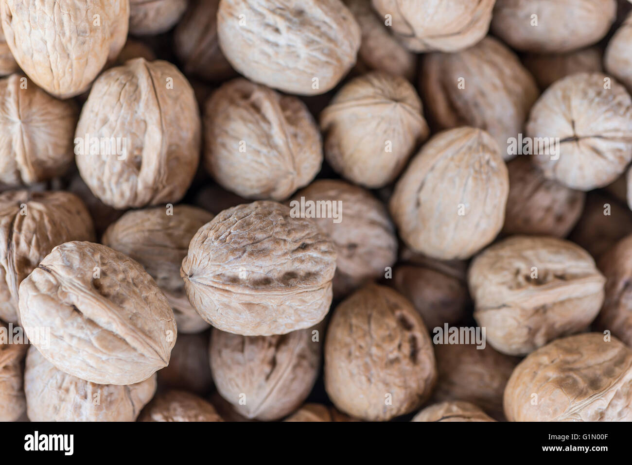 Walnuts in shells on a market Stock Photo - Alamy
