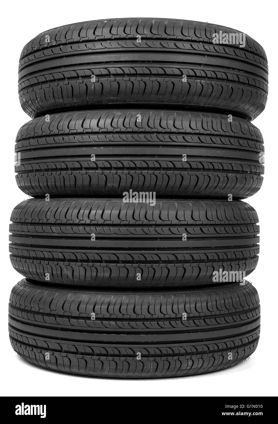 Stack of four new black tyres Stock Photo - Alamy