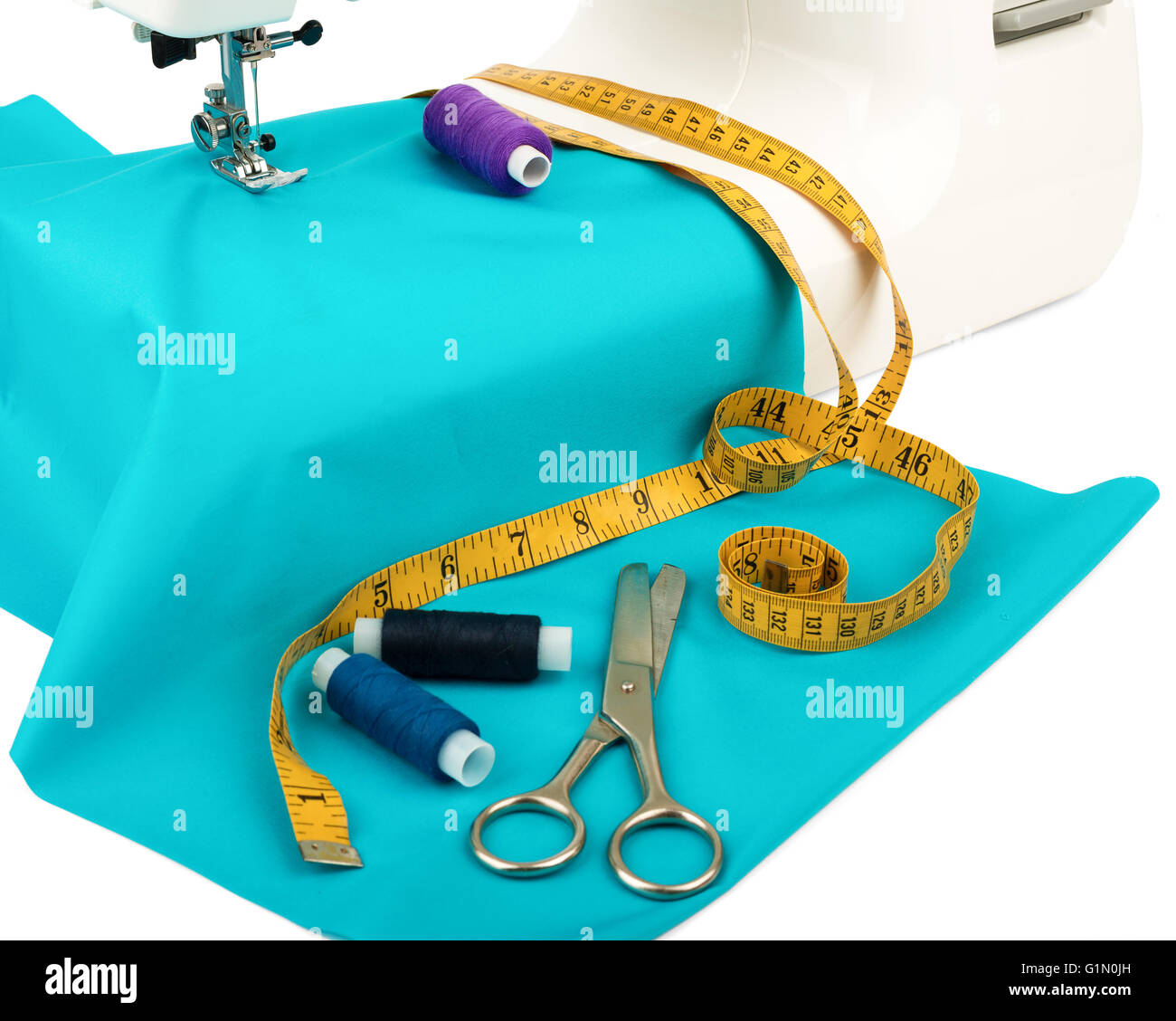 Sewing machine with fabric, threads and scissors Stock Photo - Alamy