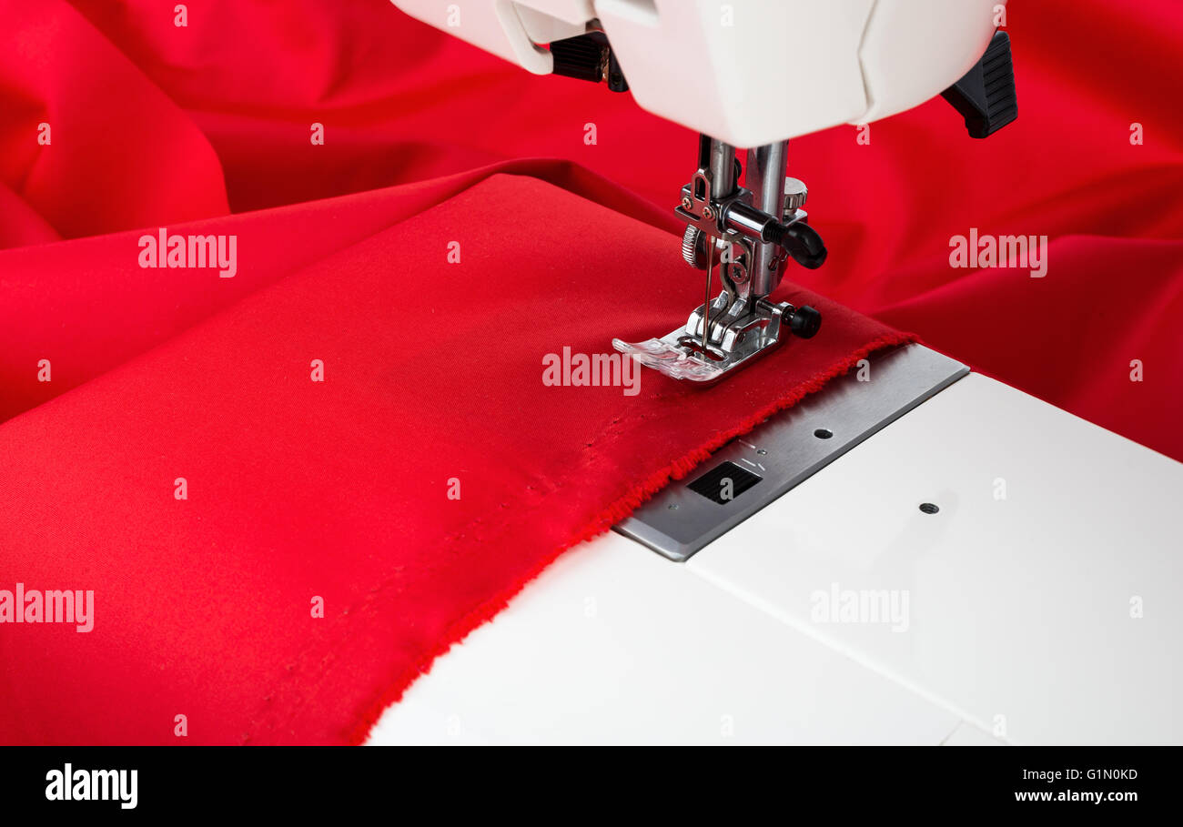 Sewing machine and red fabric isolated on white Stock Photo - Alamy