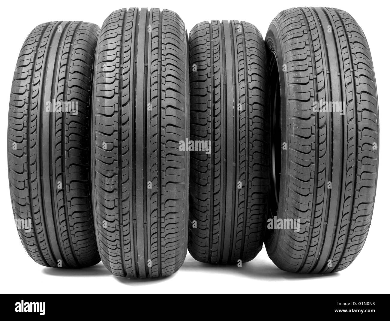 Stack of four wheel new black tyres Stock Photo - Alamy