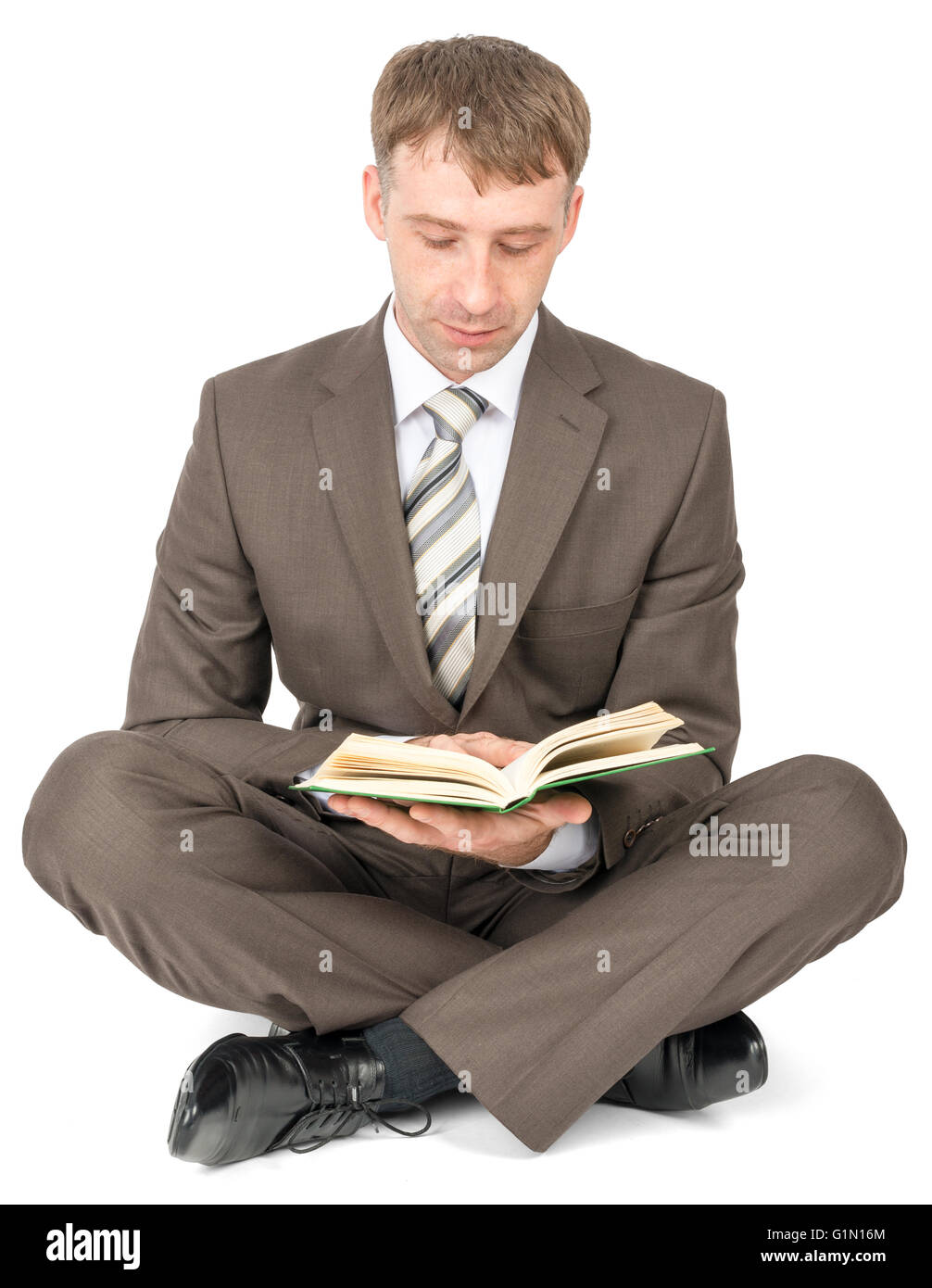 Man sitting and reading book Stock Photo - Alamy