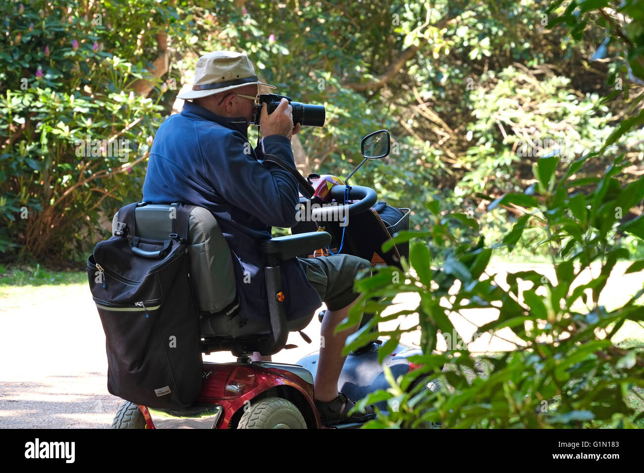 man on mobility scooter taking photograph Stock Photo - Alamy