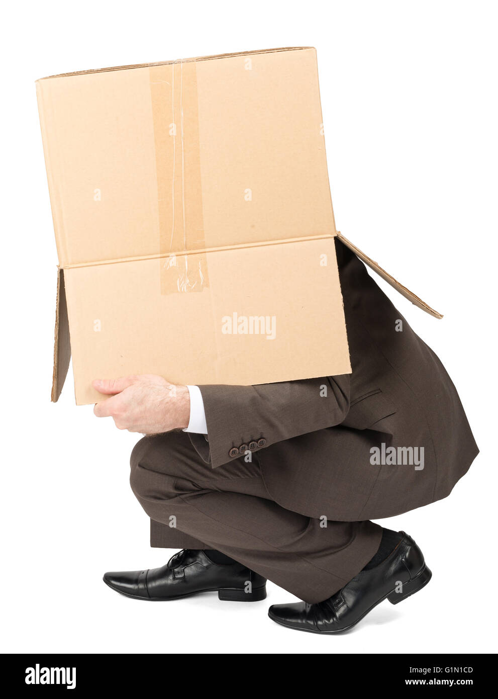Businessman hiding behind box Stock Photo - Alamy