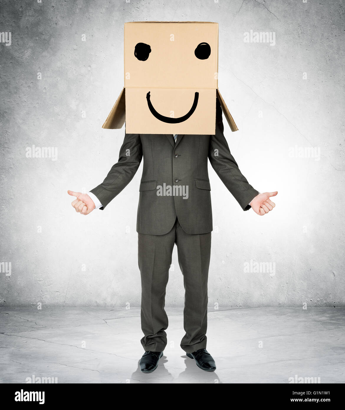 Businessman with box on head and smiley face Stock Photo - Alamy