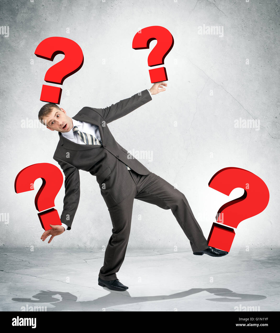 Portrait of businessman holding red question marks Stock Photo - Alamy