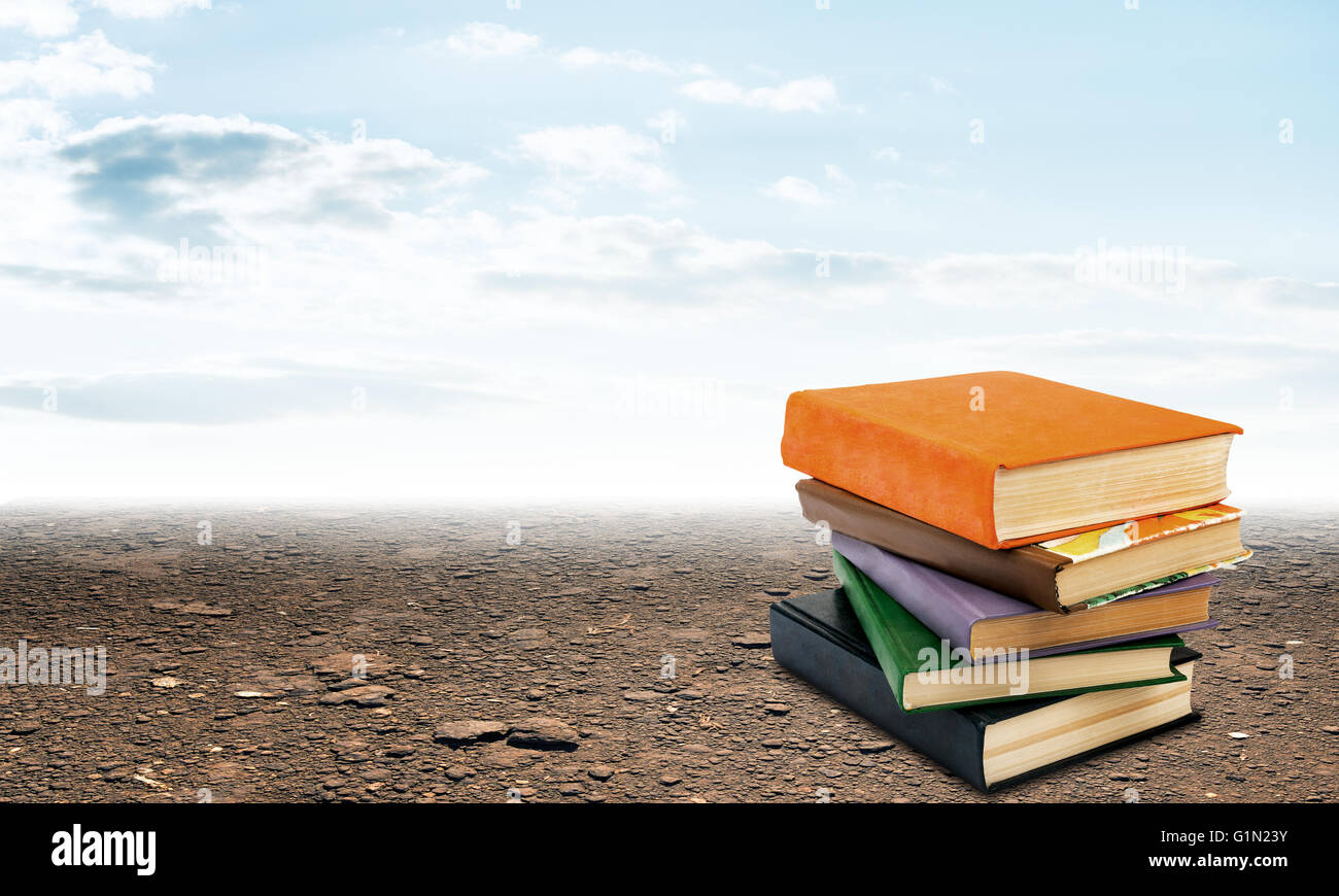 Stack of books on ground Stock Photo - Alamy