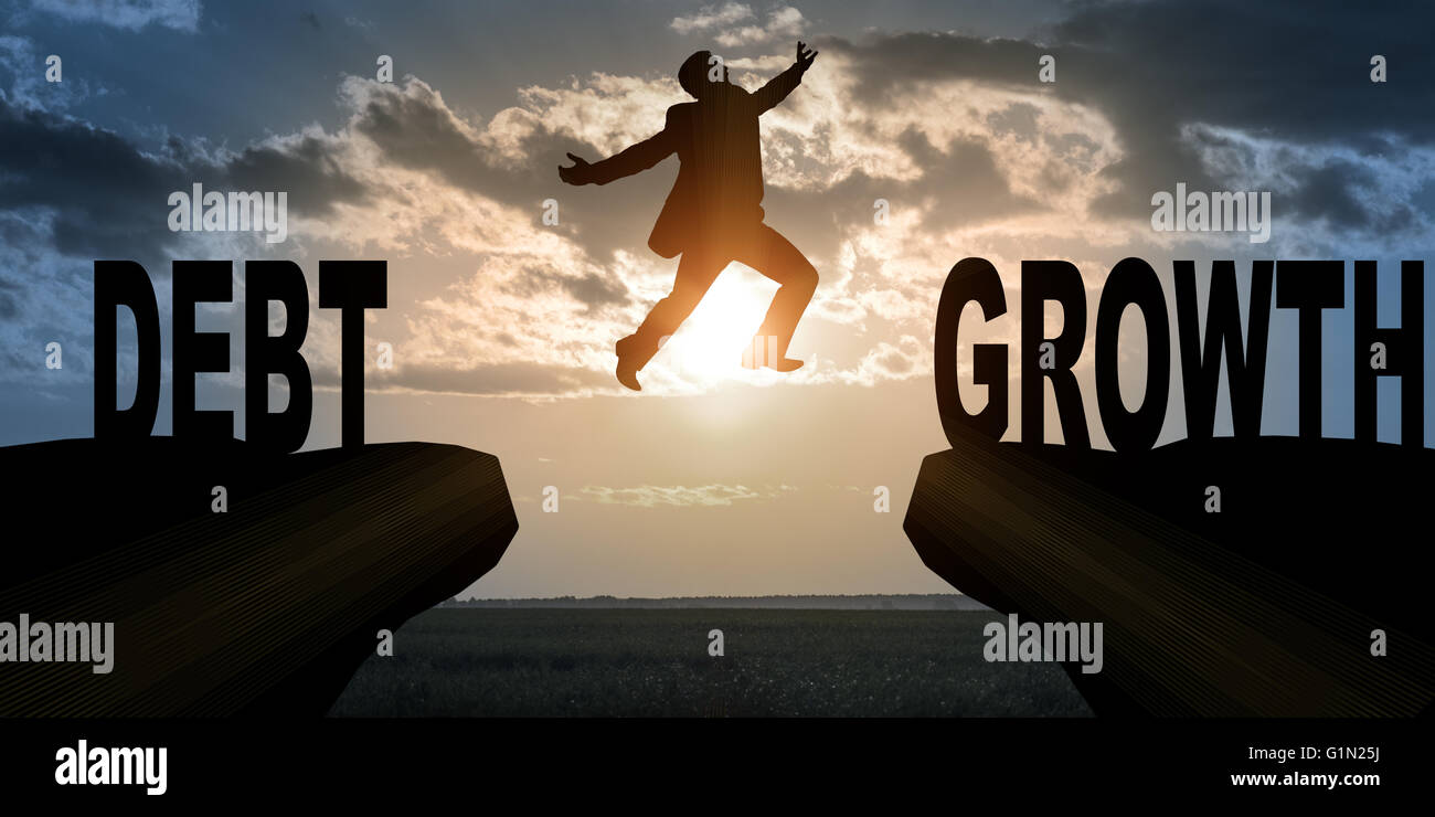 Businessman with hopping over abyss Stock Photo - Alamy