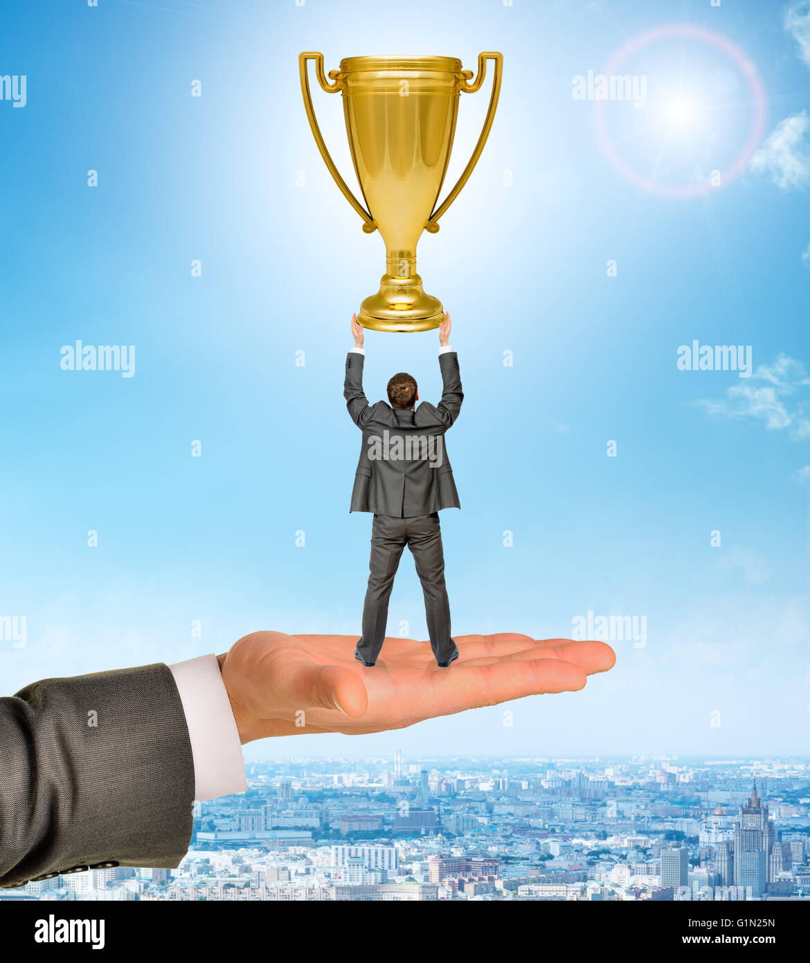 Businessman with cup on big hand Stock Photo - Alamy