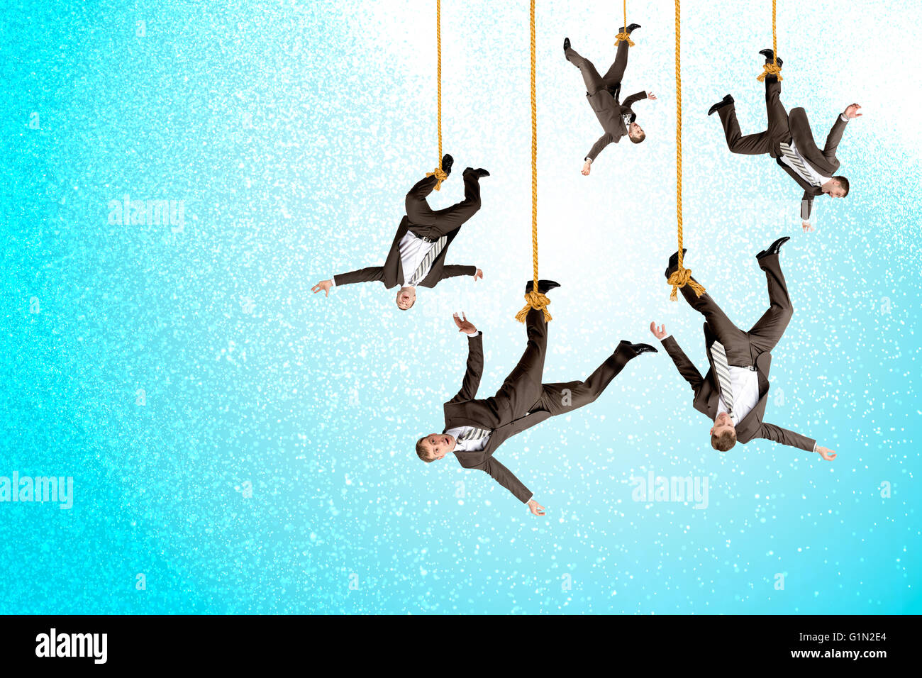 Businessmen hanging on ropes Stock Photo - Alamy