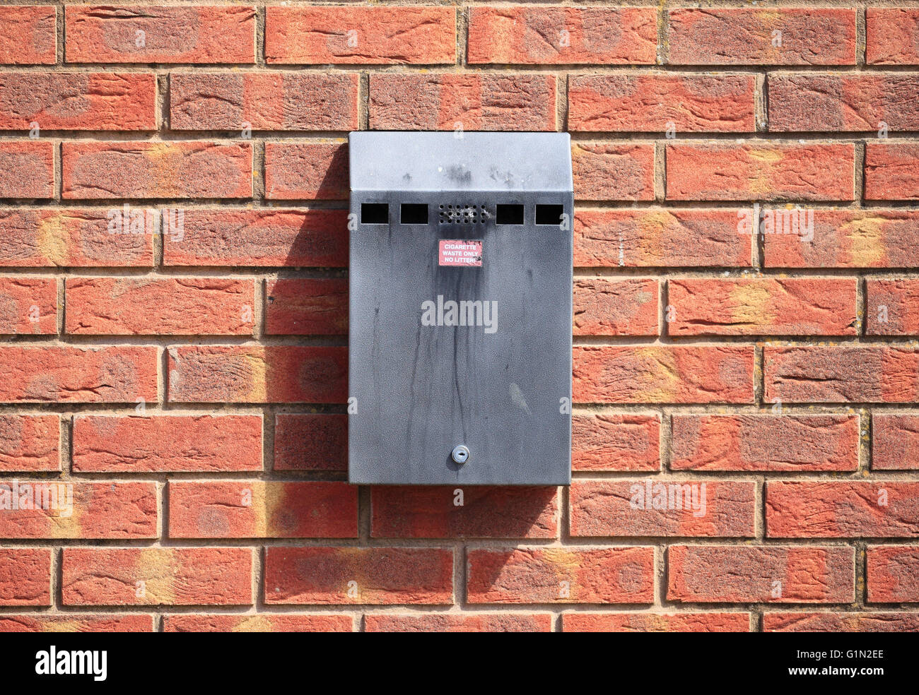 Brick wall and an outside ashtray Stock Photo - Alamy