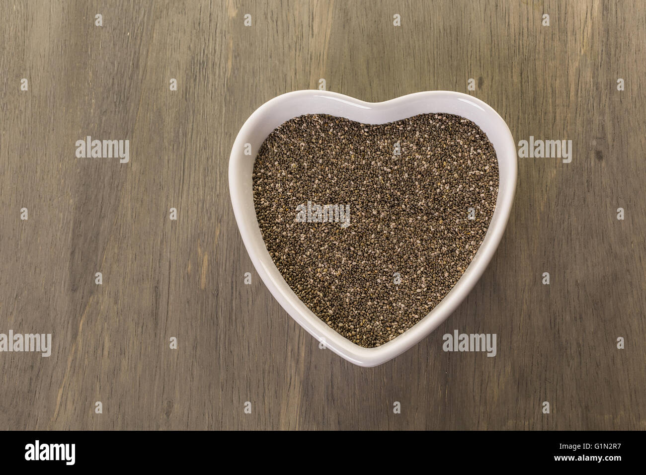 Healthy Chia seeds in a heart shape bowl close-up Stock Photo - Alamy