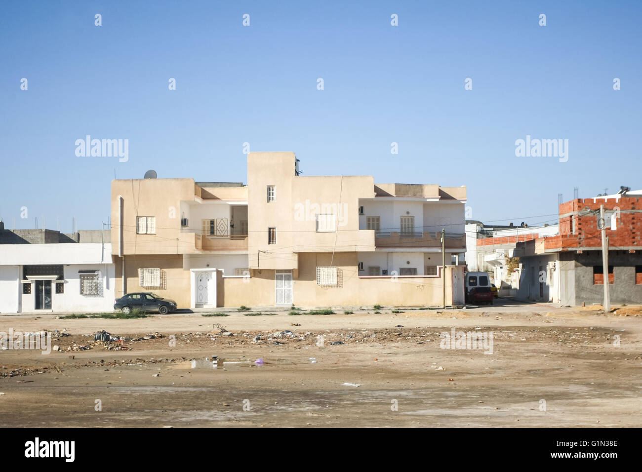 Residential buildings and typical dusty and dirty street full of ...