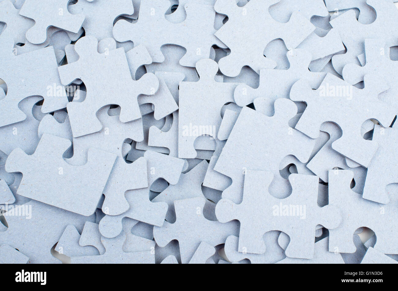 Pile of grey blank puzzle pieces background Stock Photo - Alamy