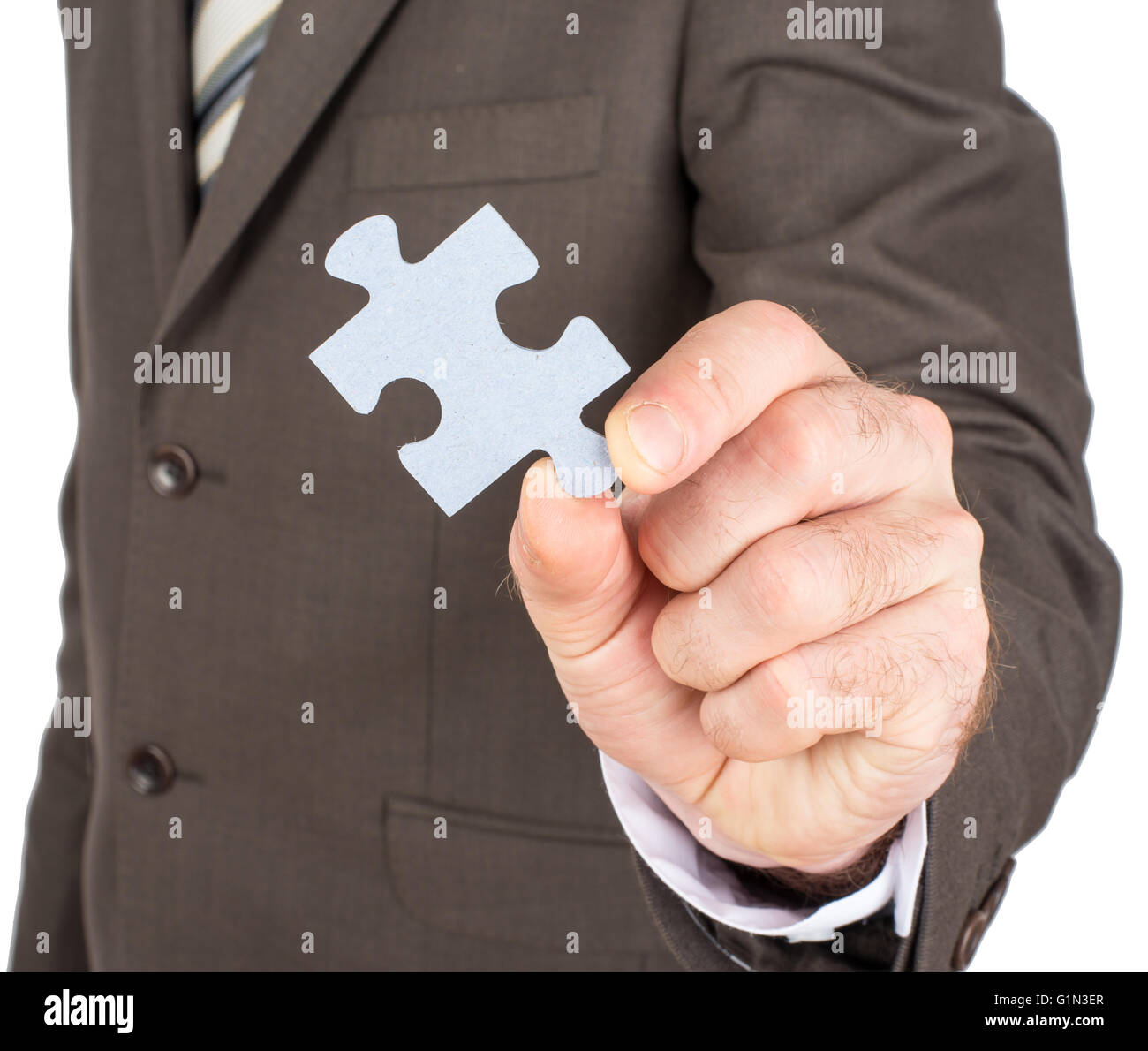 Close up of businessman hand holding puzzle piece Stock Photo - Alamy
