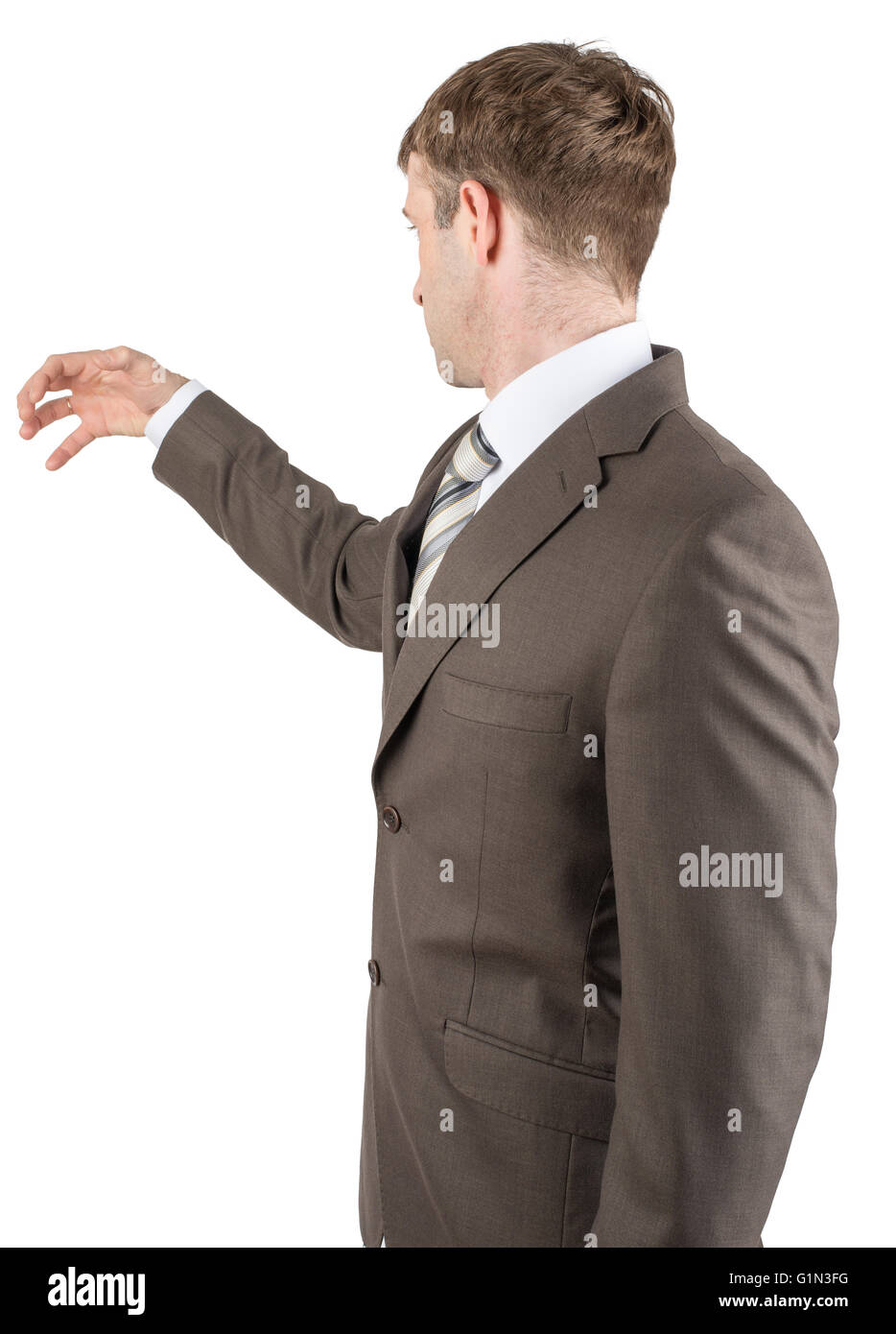 Man in suit reaching for something from Stock Photo - Alamy