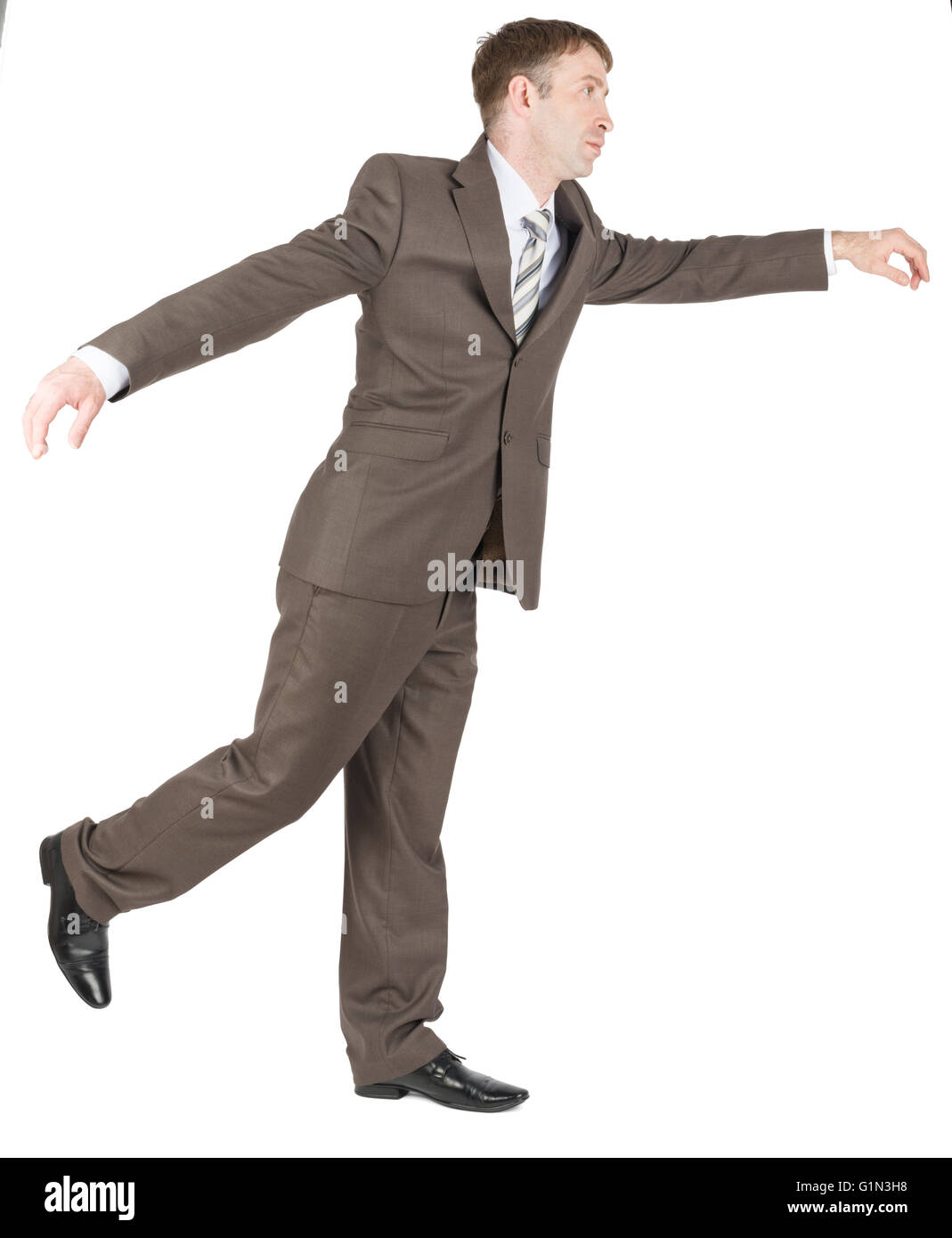 Businessman balancing on one leg Stock Photo - Alamy