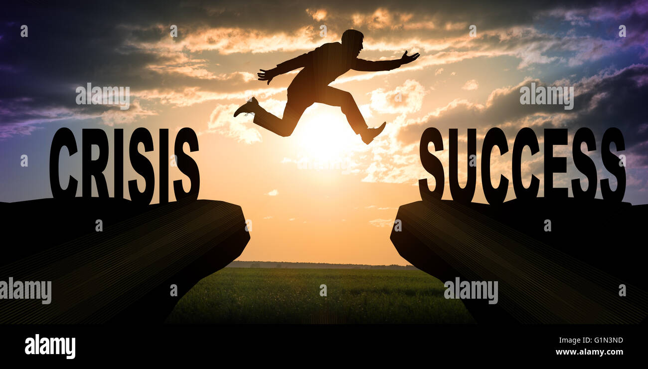 Businessman with hopping over abyss Stock Photo - Alamy