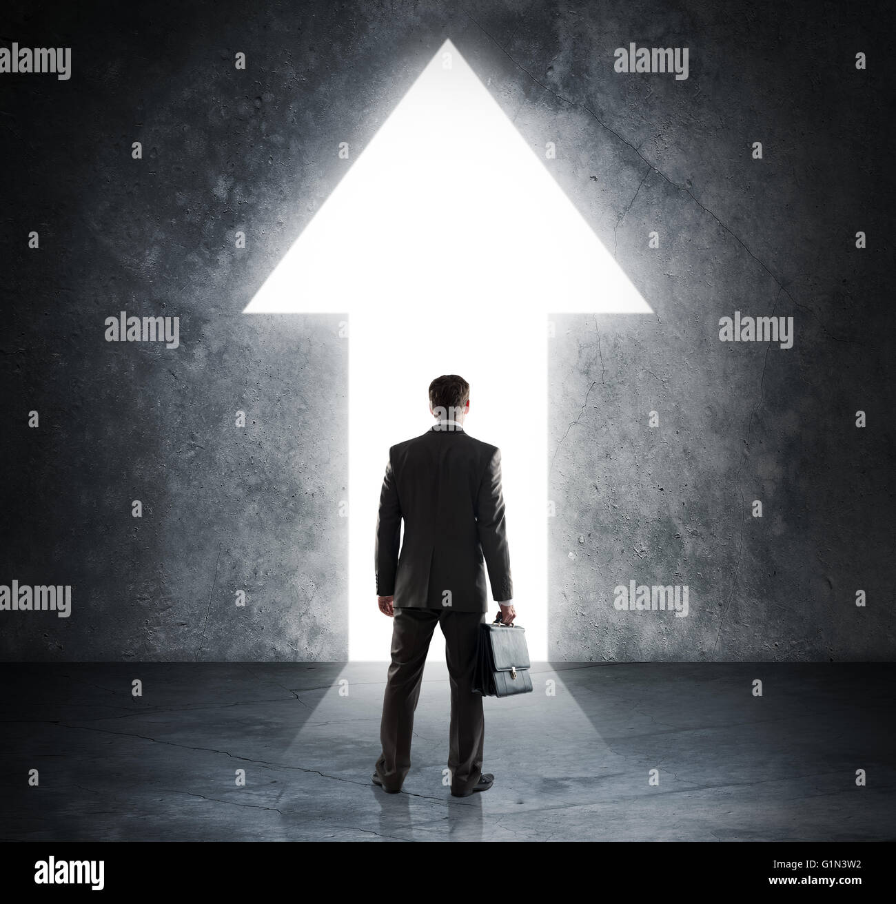 Business person with solution arrow on wall Stock Photo - Alamy