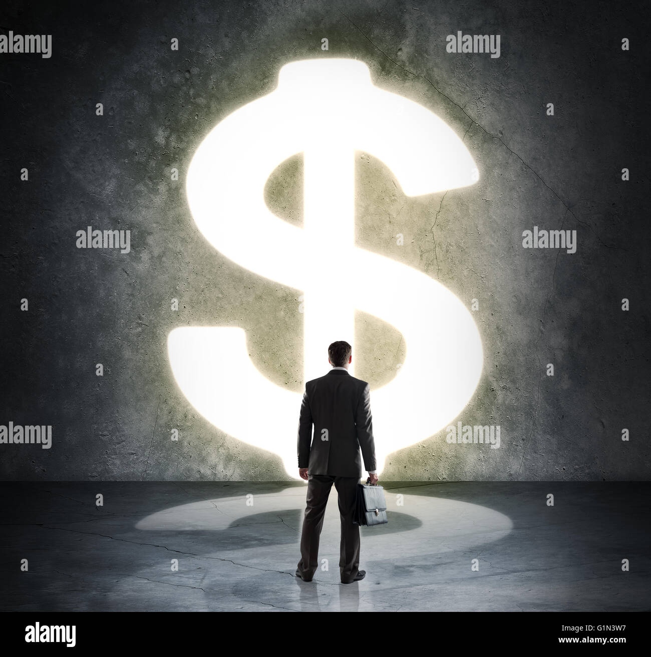 Businessman standing in light of dollar sign Stock Photo - Alamy