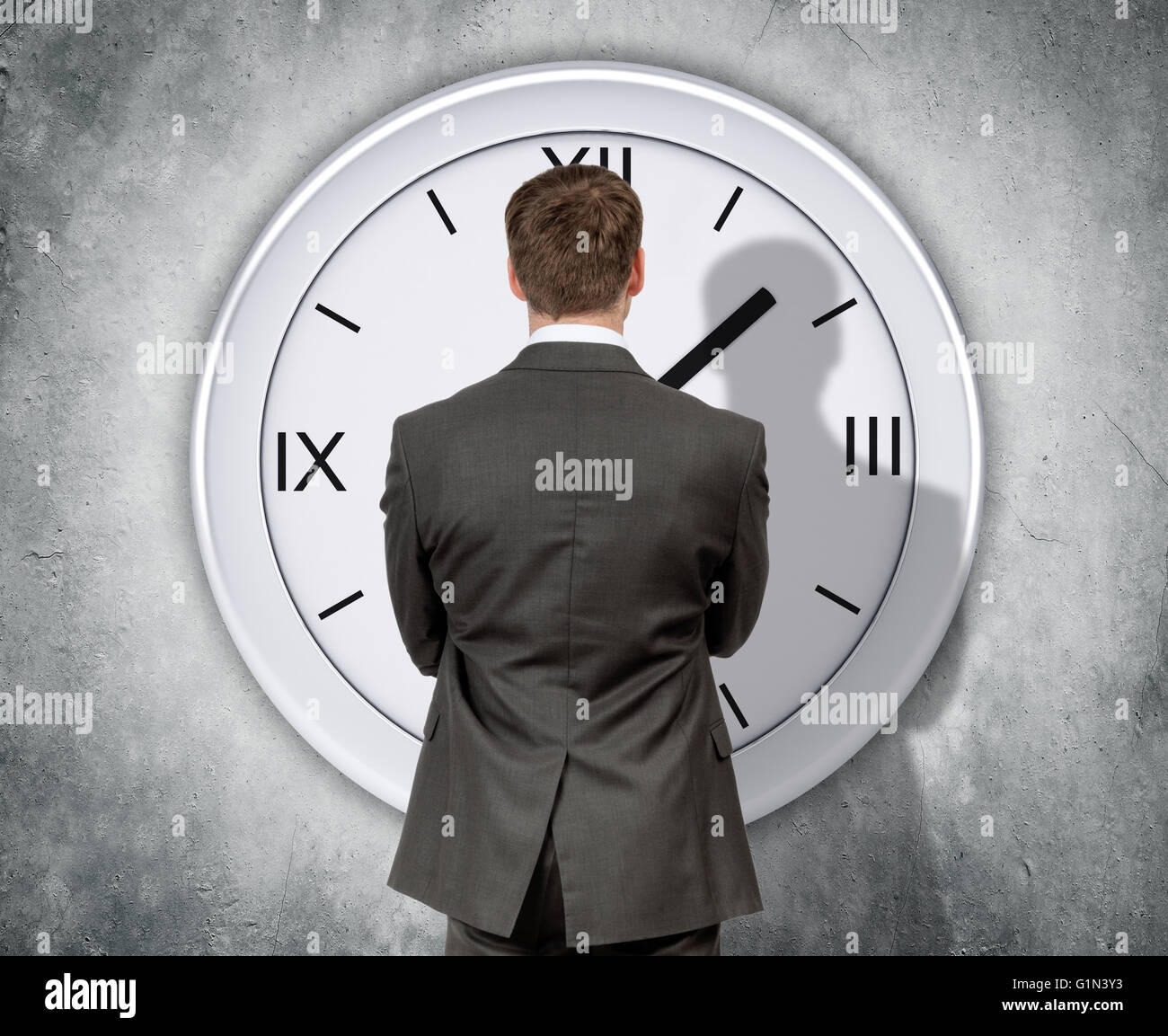 Businessman looking at clock Stock Photo - Alamy
