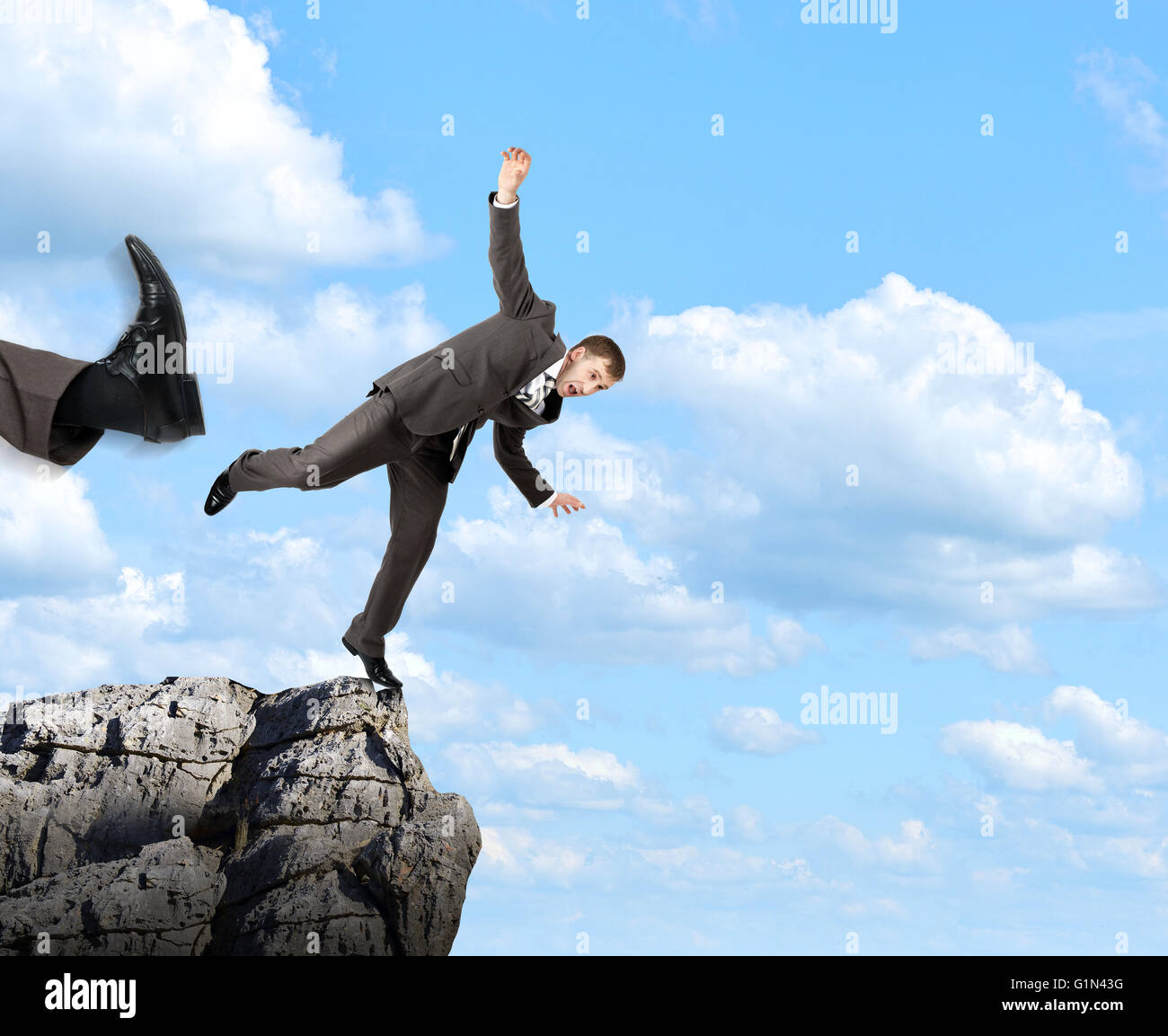 Businessman kicked by his boss big foot Stock Photo - Alamy