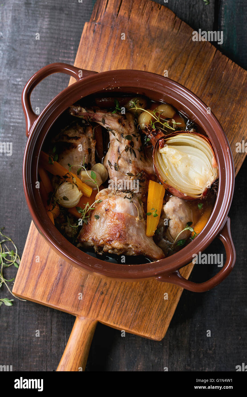 Brown ceramic pot with stewed rabbit with bouillon, vegetables and ...