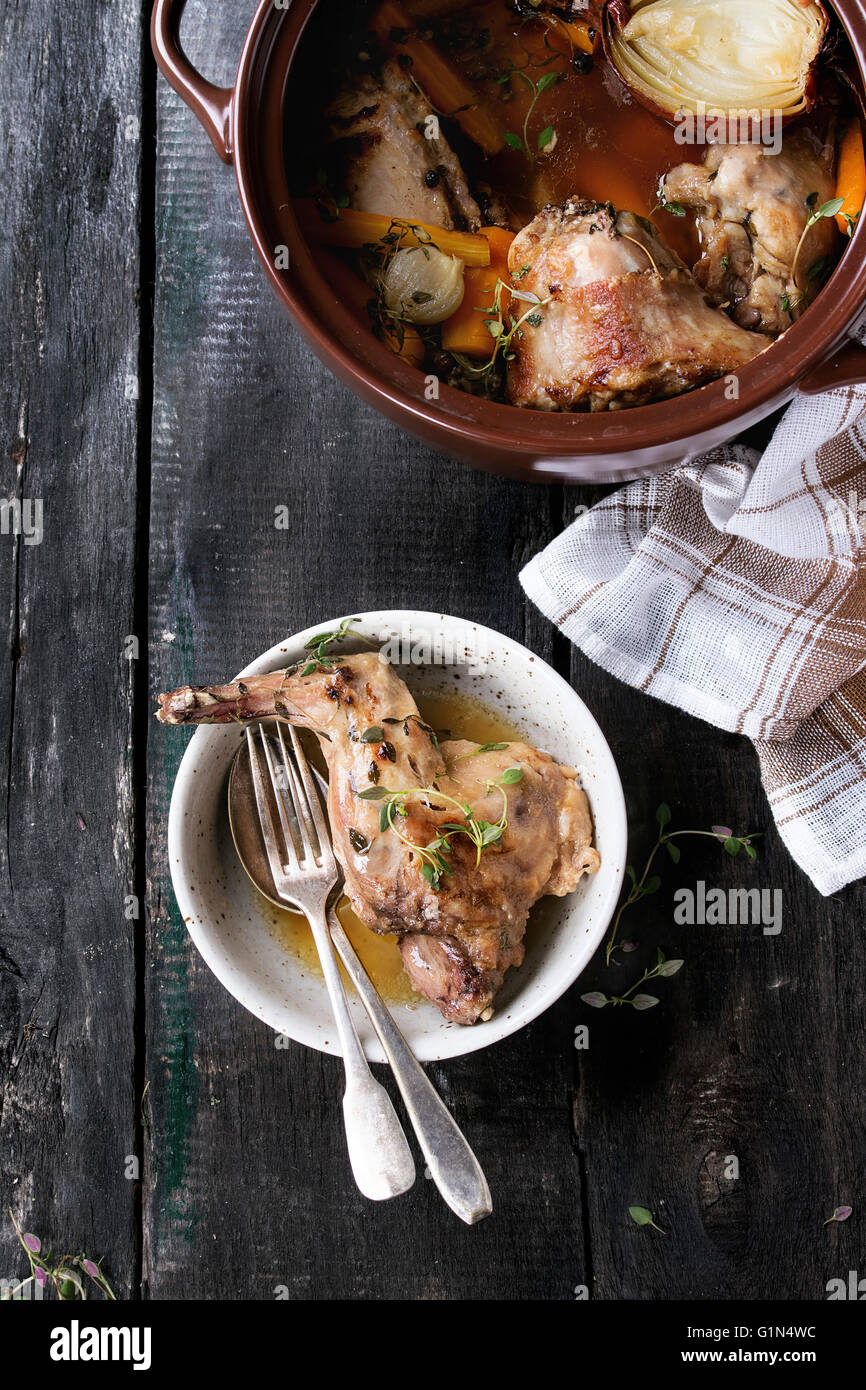Brown ceramic pot with stewed rabbit with bouillon, vegetables and ...