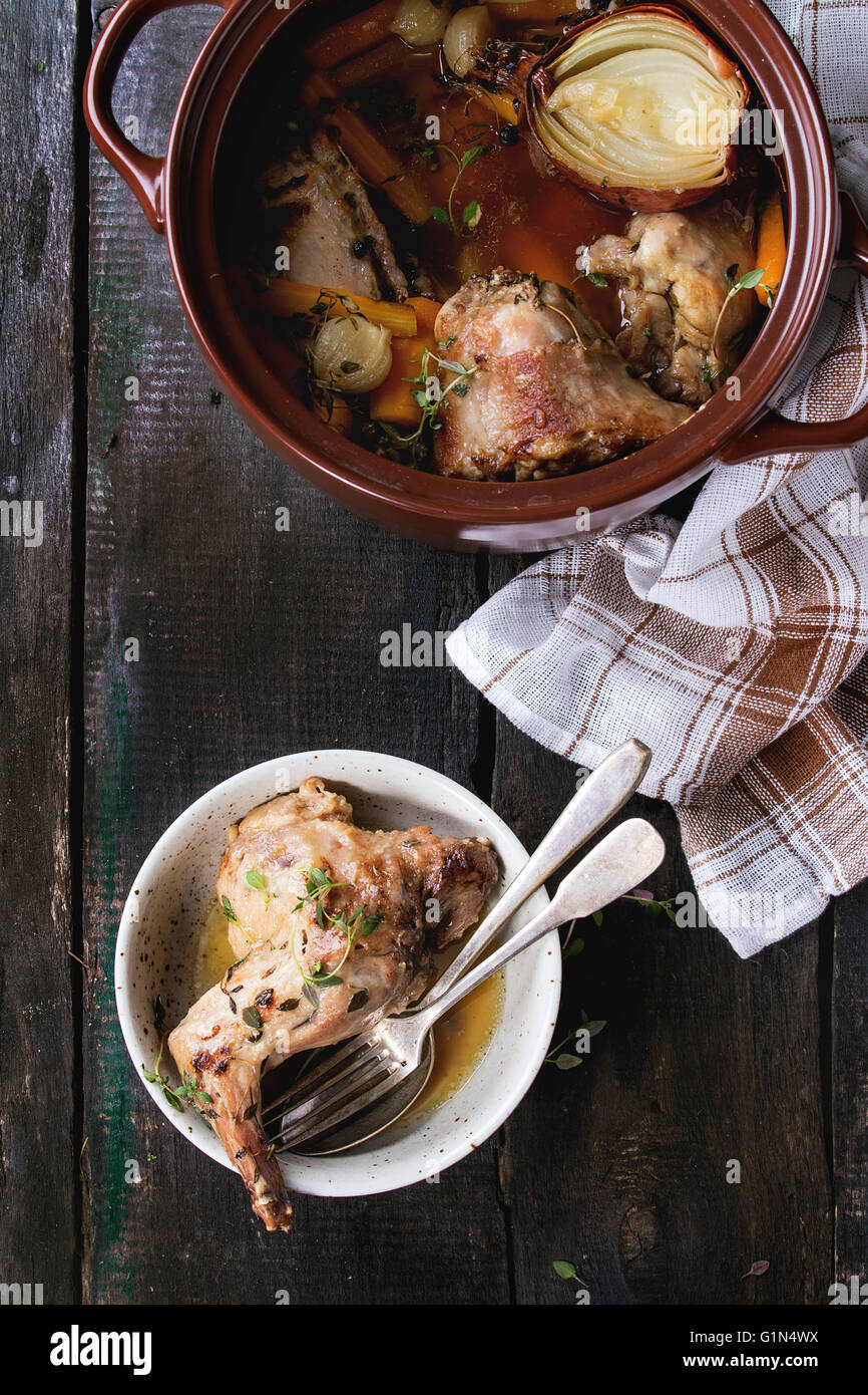 Brown ceramic pot with stewed rabbit with bouillon, vegetables and ...