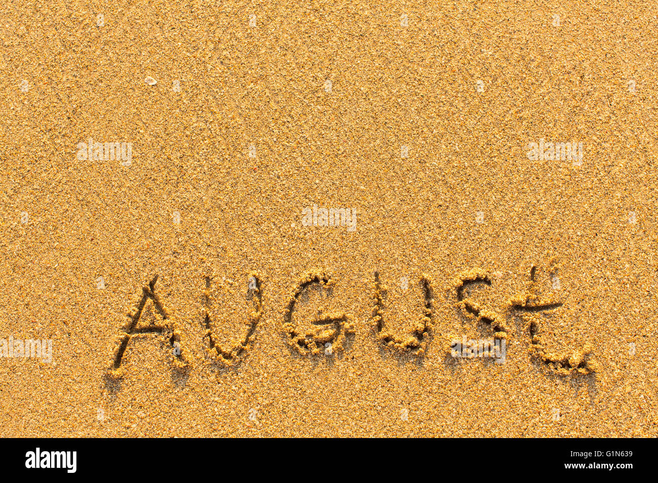 August - word inscription on the gold sand sea beach Stock Photo - Alamy