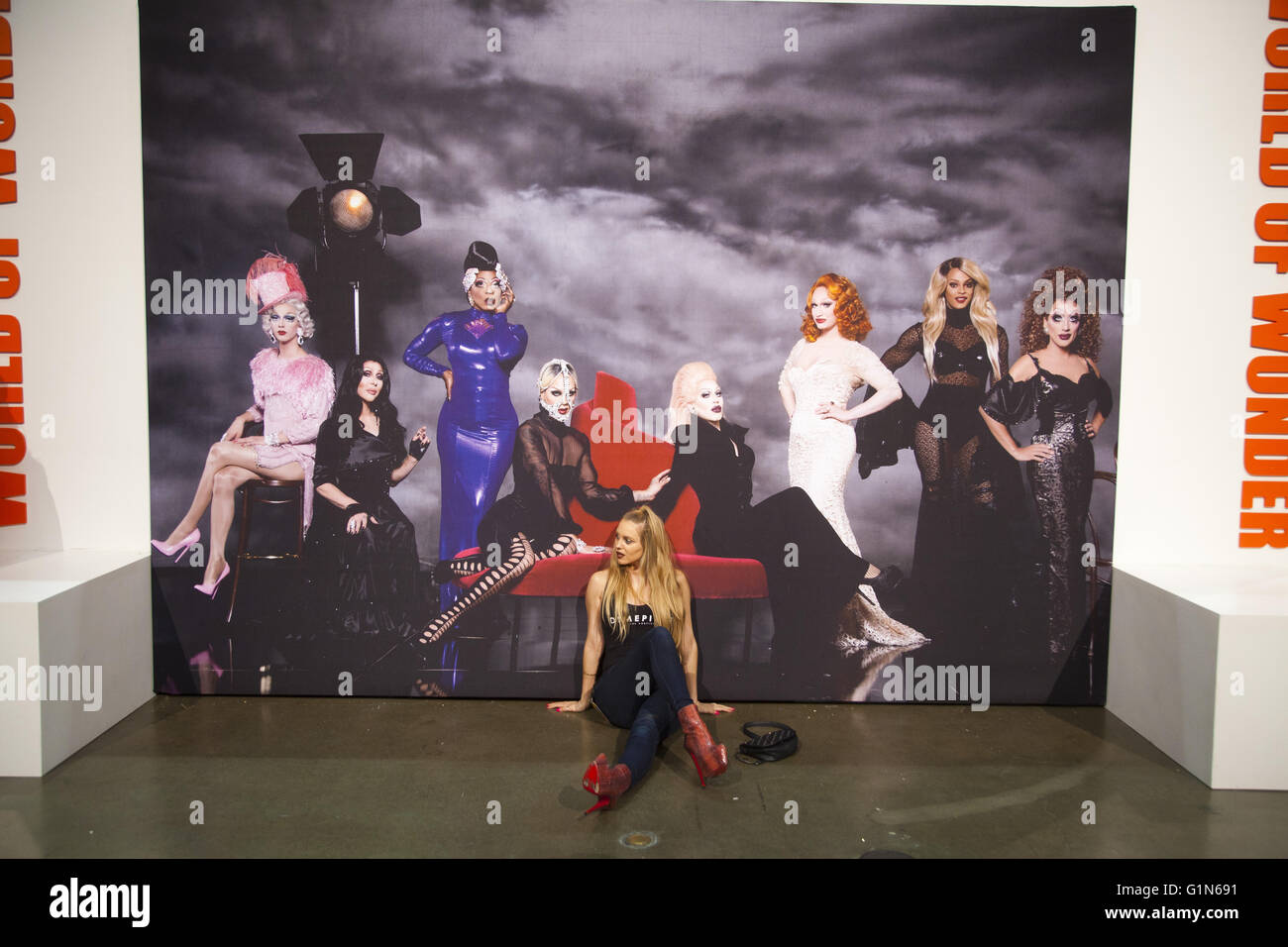 Posing in front of a mural depicting famous drag queens, RuPaul's ...