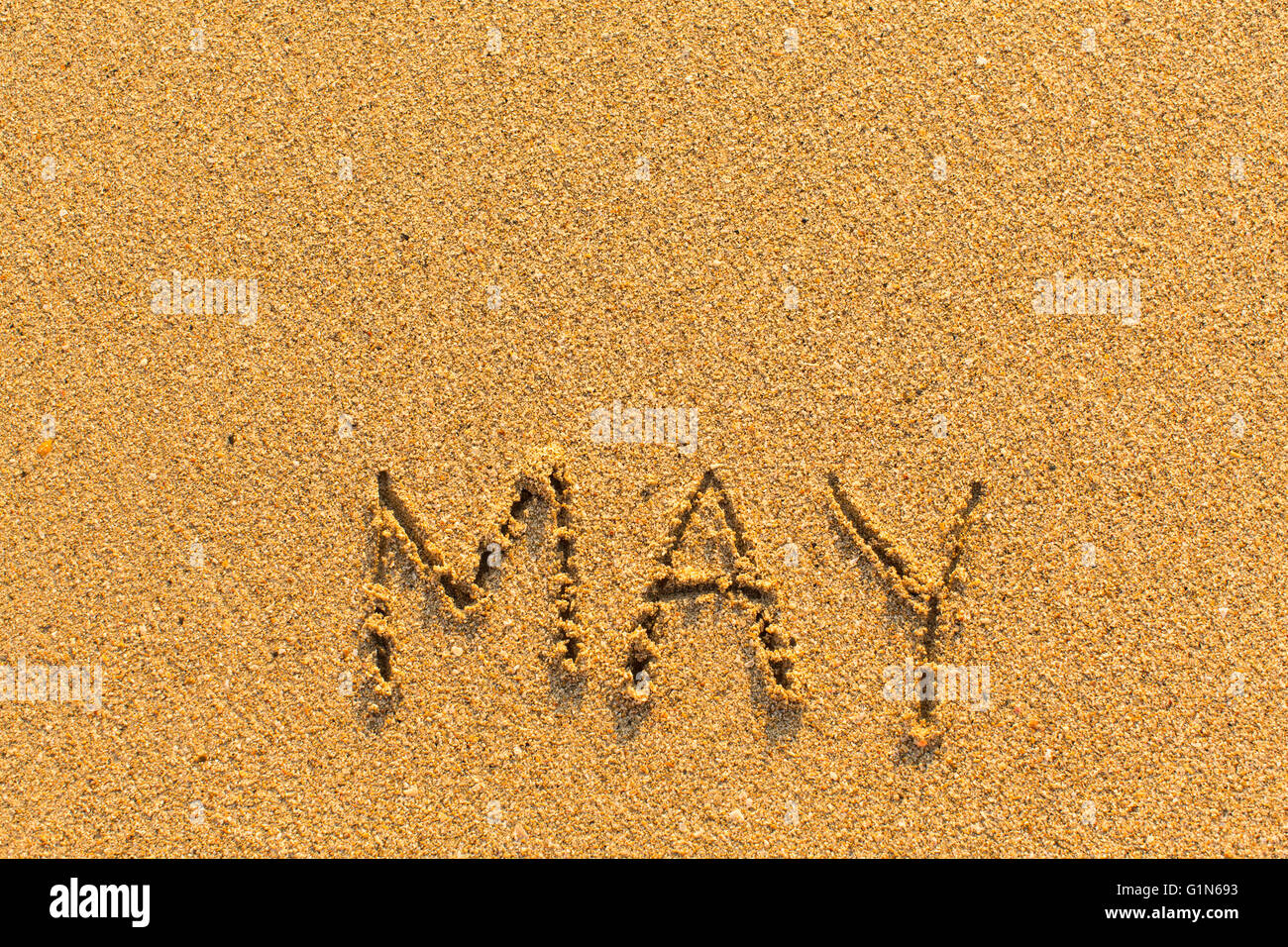May - word inscription on the gold sand sea beach Stock Photo - Alamy