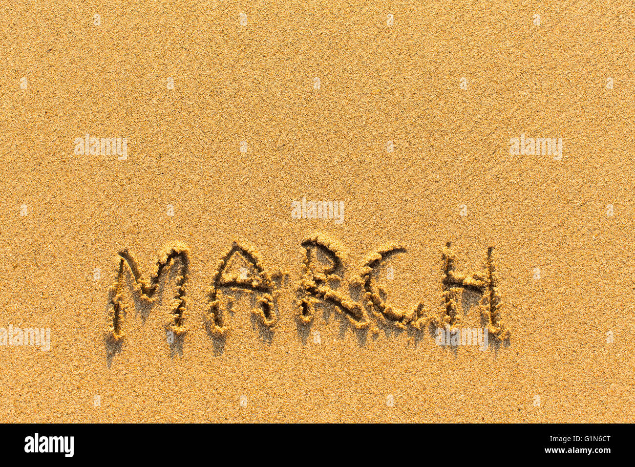 March - word inscription on the gold sand sea beach Stock Photo - Alamy