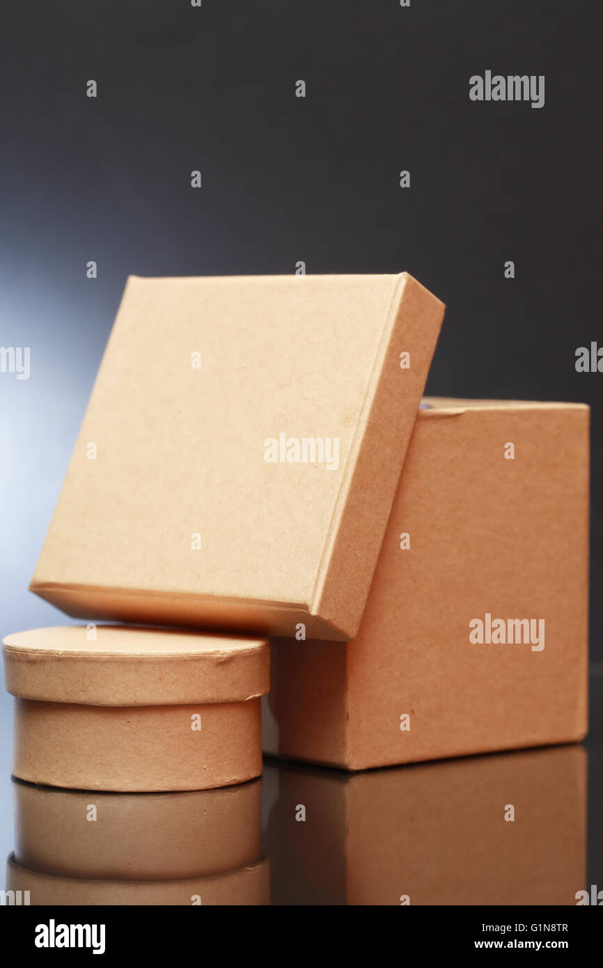 Two cardboard boxes with reflection on dark background Stock Photo - Alamy