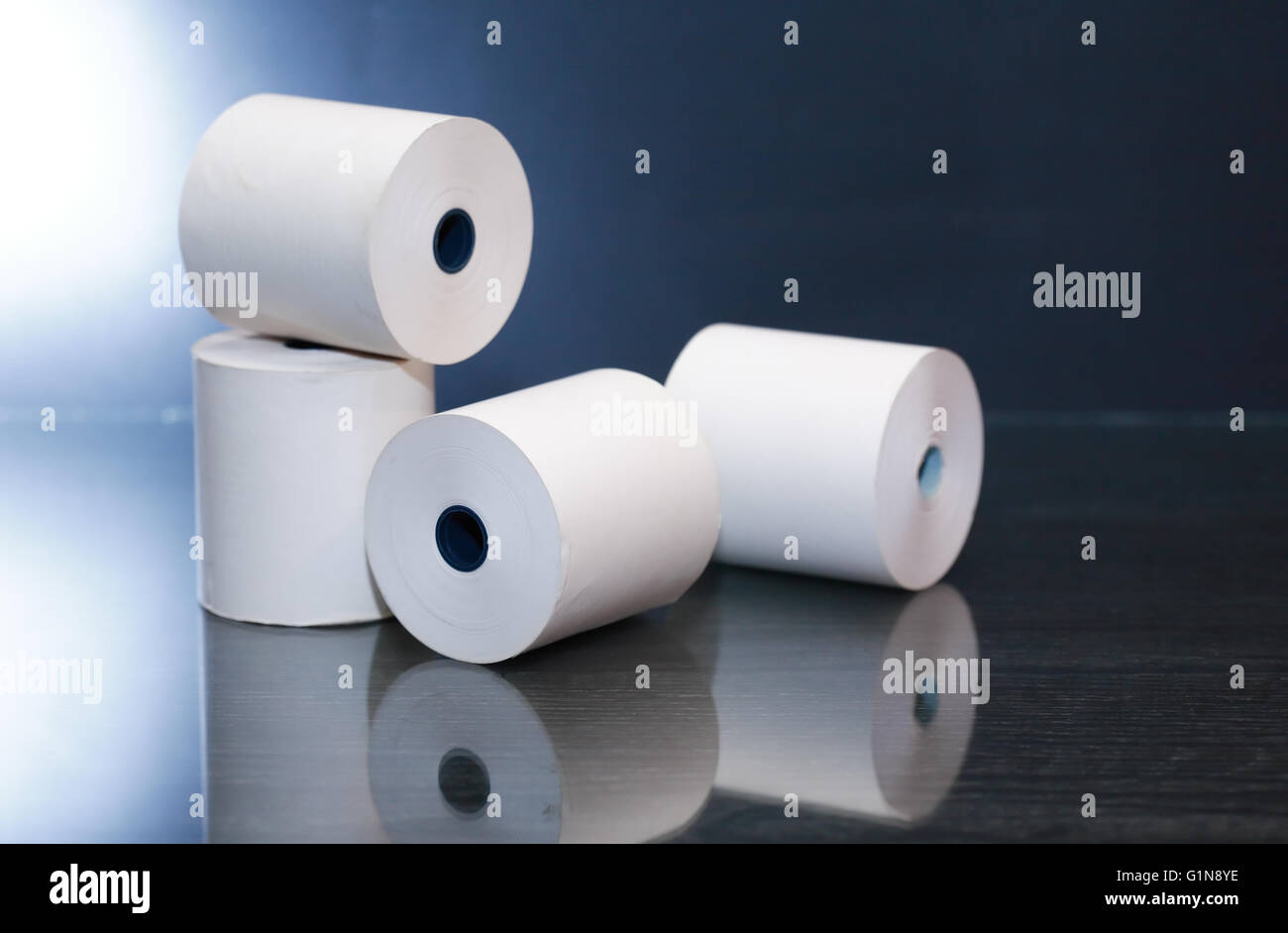 White paper rolls with reflection on dark background Stock Photo - Alamy
