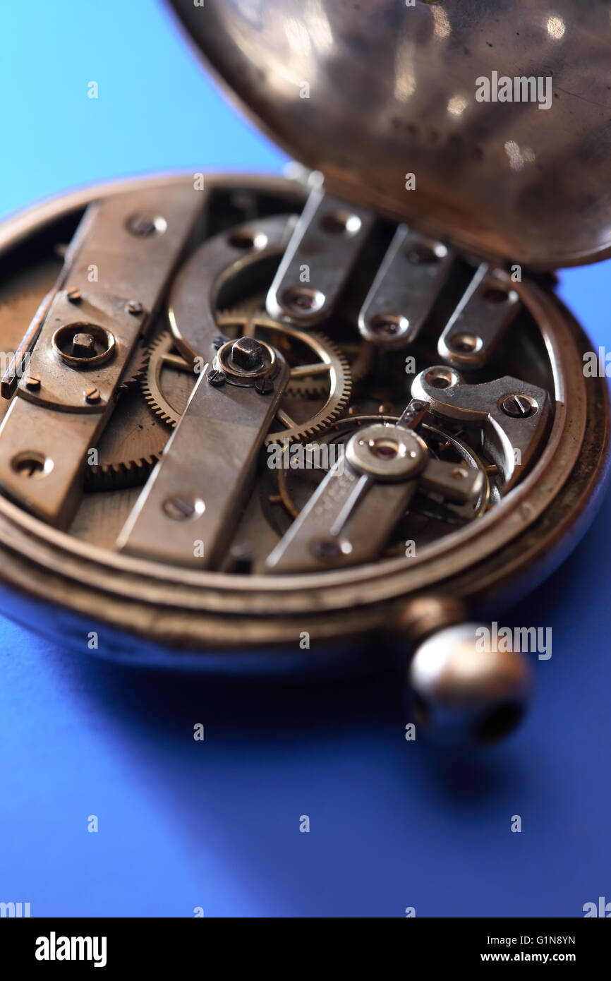 Old pocket watch back side with open mechanism on blue background Stock ...