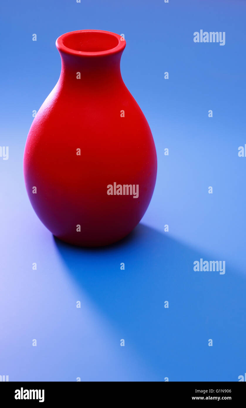 Nice red ceramic vase on blue background with long shadow Stock Photo ...