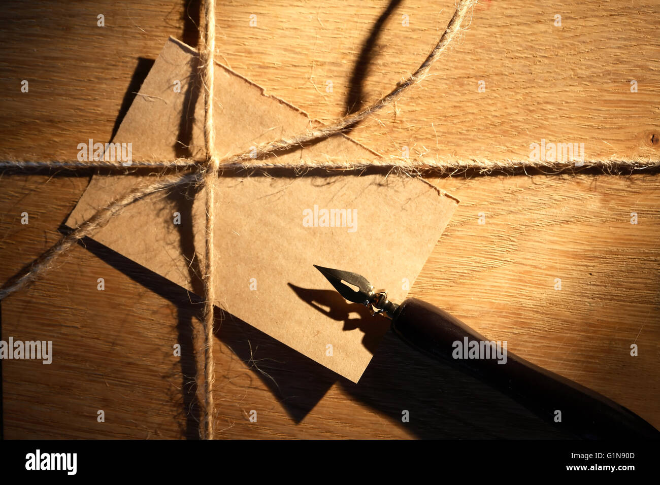Nice oak timber tied with rope. Fountain pen and blank paper under rope ...