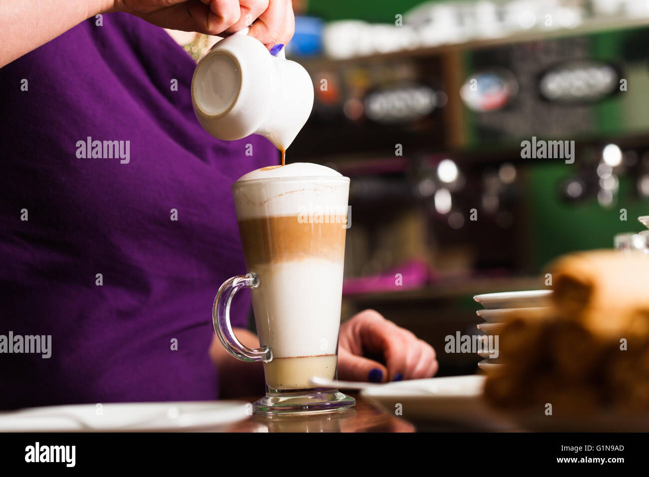 Female barista holding metal hi-res stock photography and images - Alamy