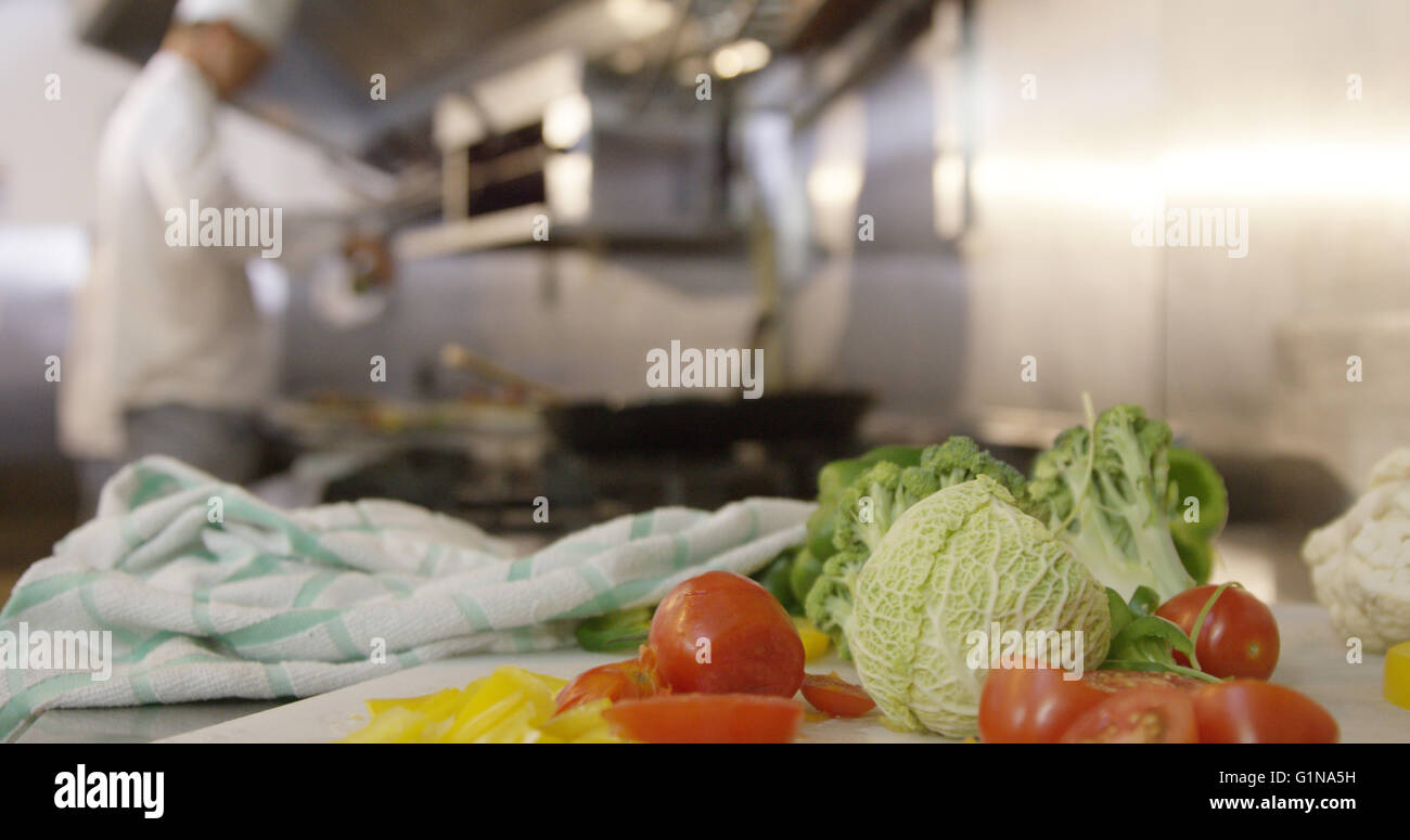 Chief cooking and focus on vegetables Stock Photo - Alamy