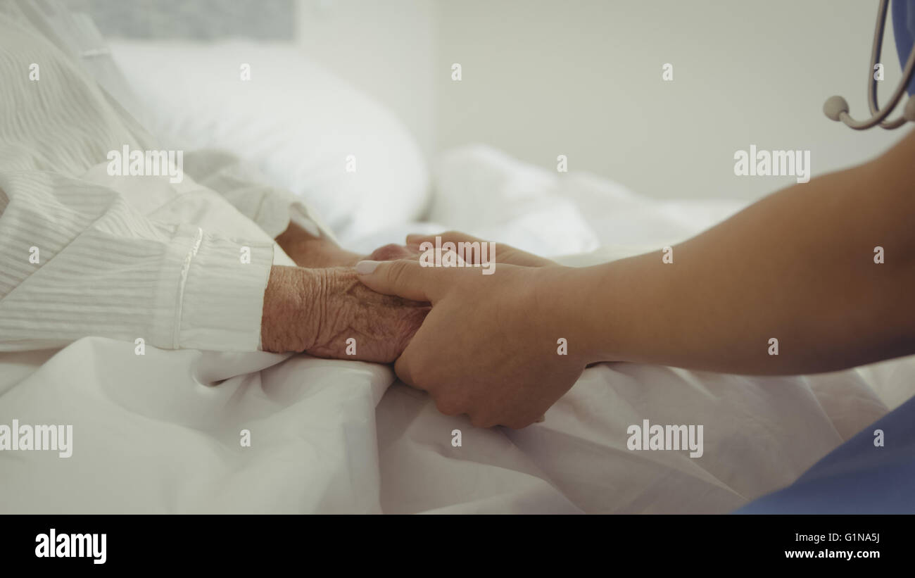 Nurse holding patient hands Stock Photo - Alamy